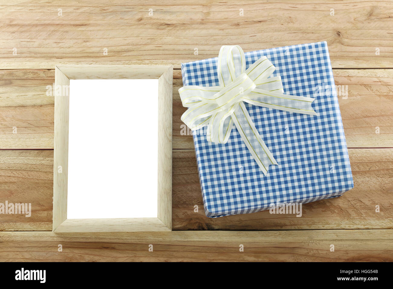 Blue gift box place near wooden frame on the wood floor in concept of ...