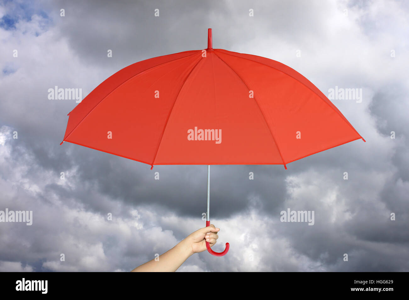 Red umbrella in hand and rain protection,concept for management ...