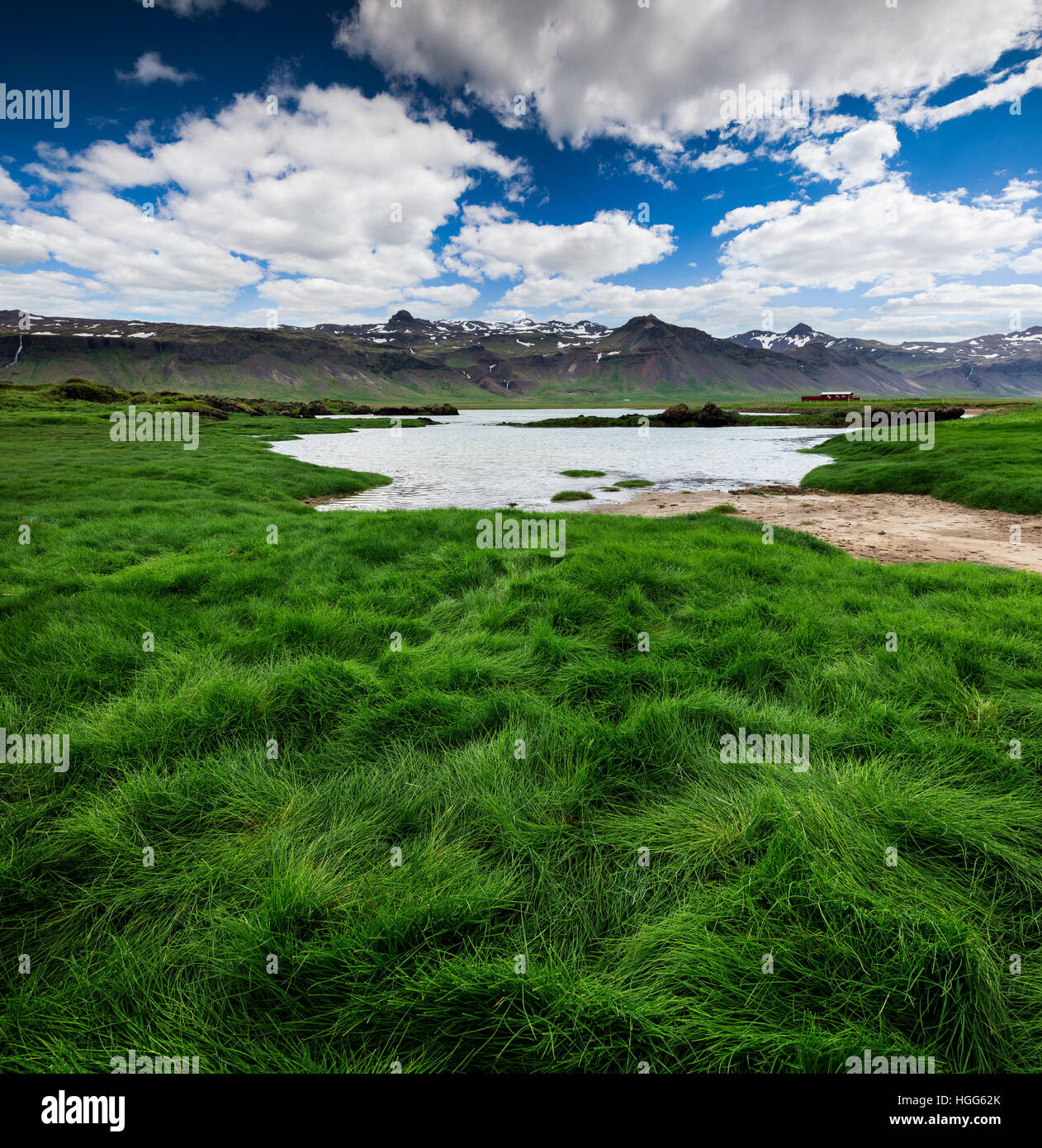 Green grass valley in the volcanic mountains foothill. Sunny summer ...
