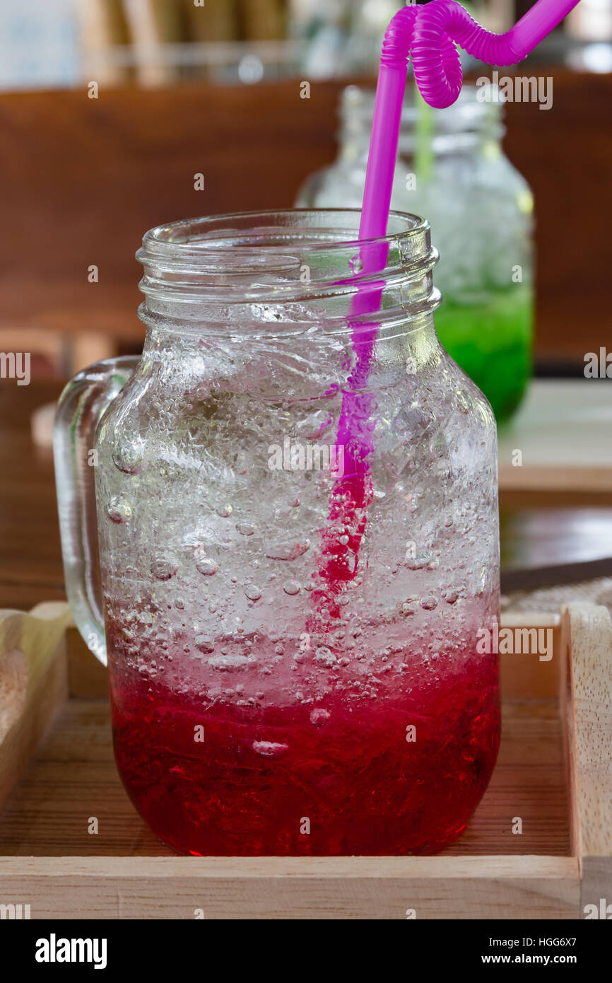 Red water mix soda on table background,process color Stock Photo - Alamy