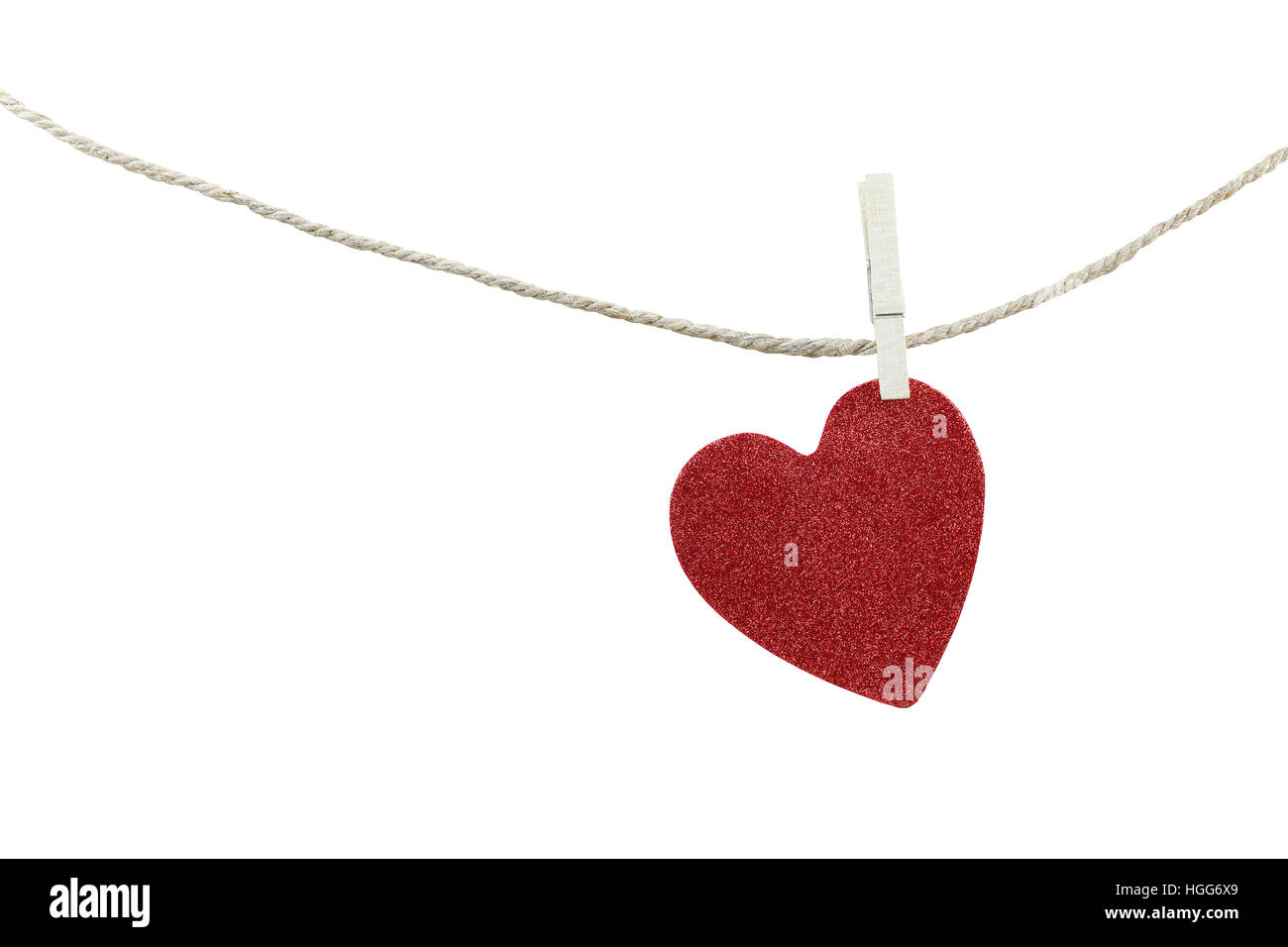 Red heart shape hanging on a hemp rope isolated on white background and ...