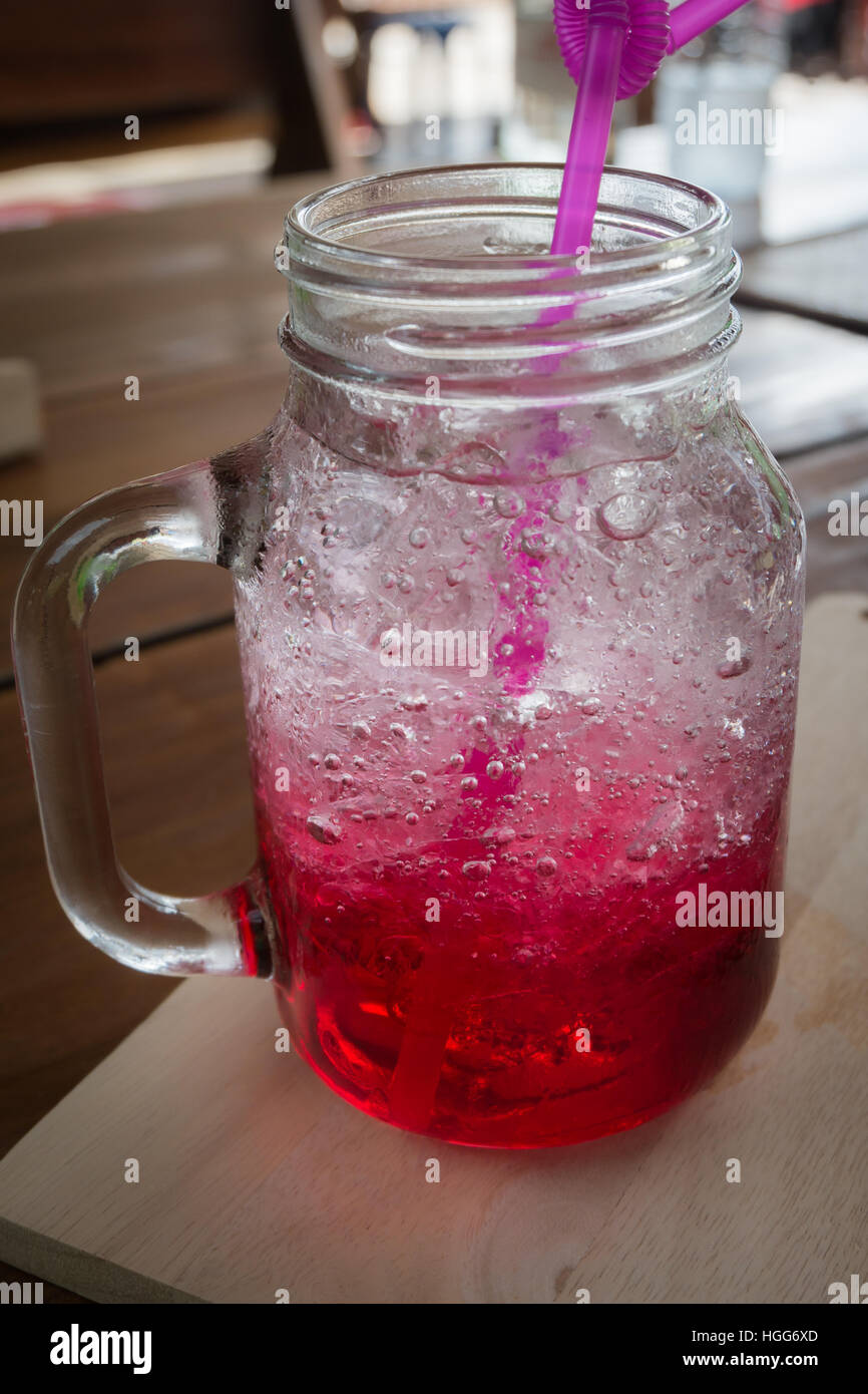 Red water mix soda on table background,process color Stock Photo - Alamy