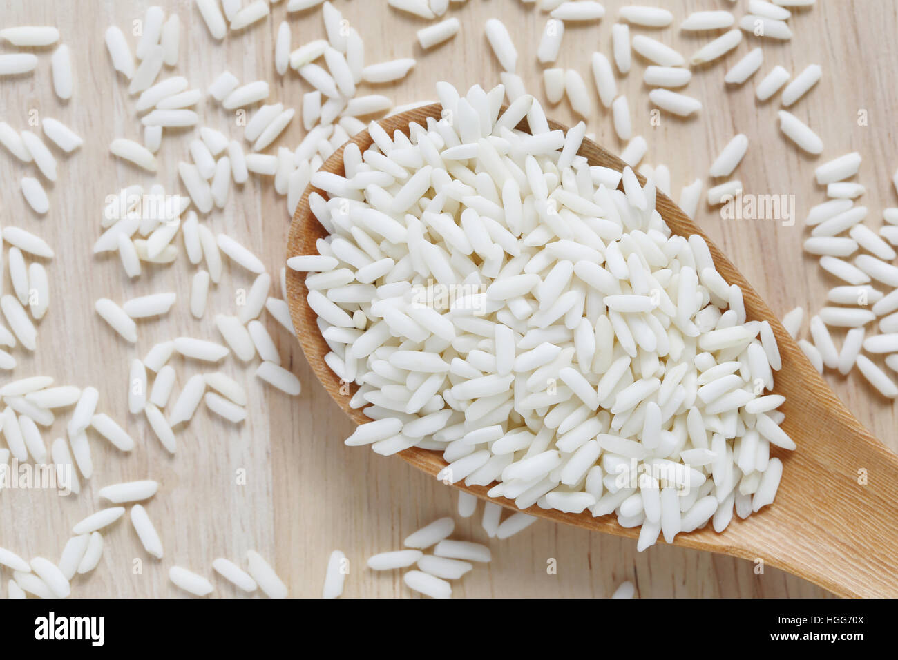 Organic white rice in wooden spoon, glutinous rice or sticky rice for ...