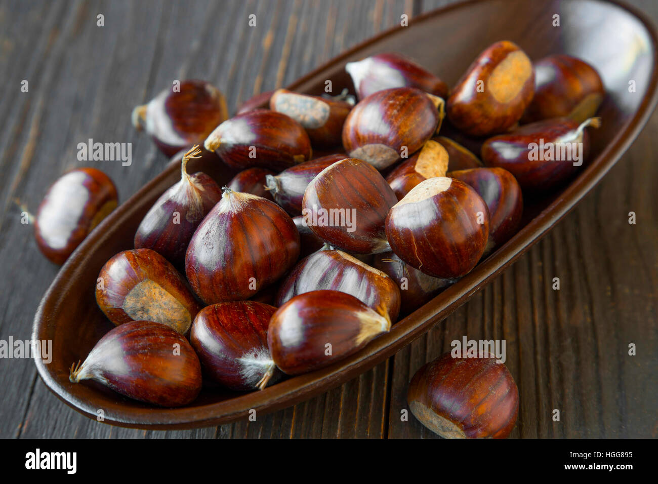 Edible chestnuts in wooden bowl Stock Photo - Alamy