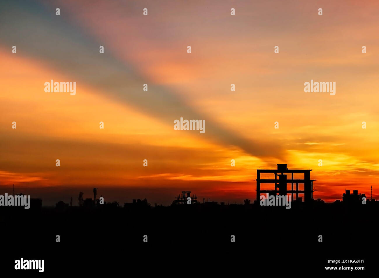Setting sun behind construction building in Bangladesh Stock Photo - Alamy