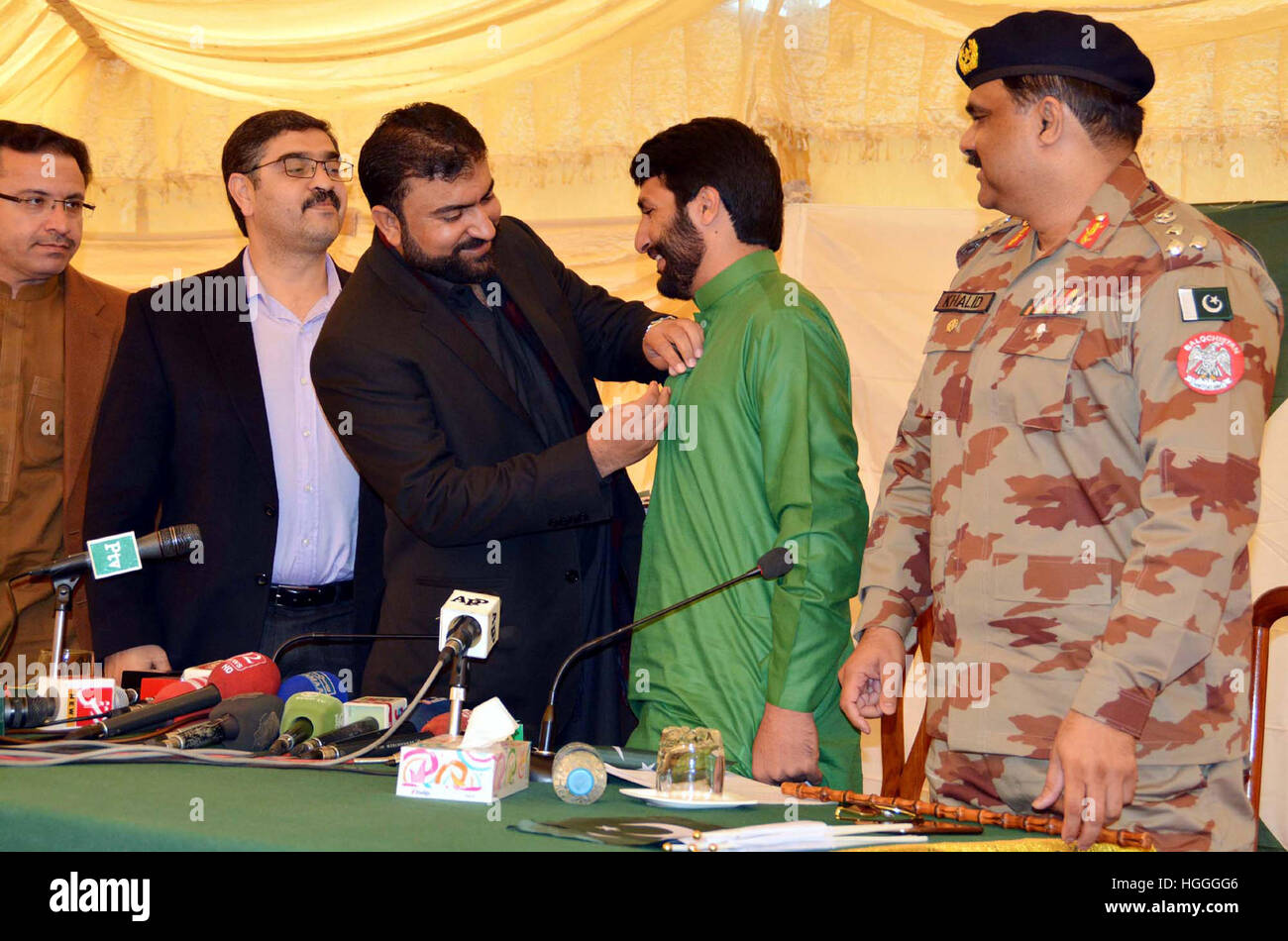 Balochistan Home Minister, Sarfraz Bugti is pinning Pakistan flag on ...