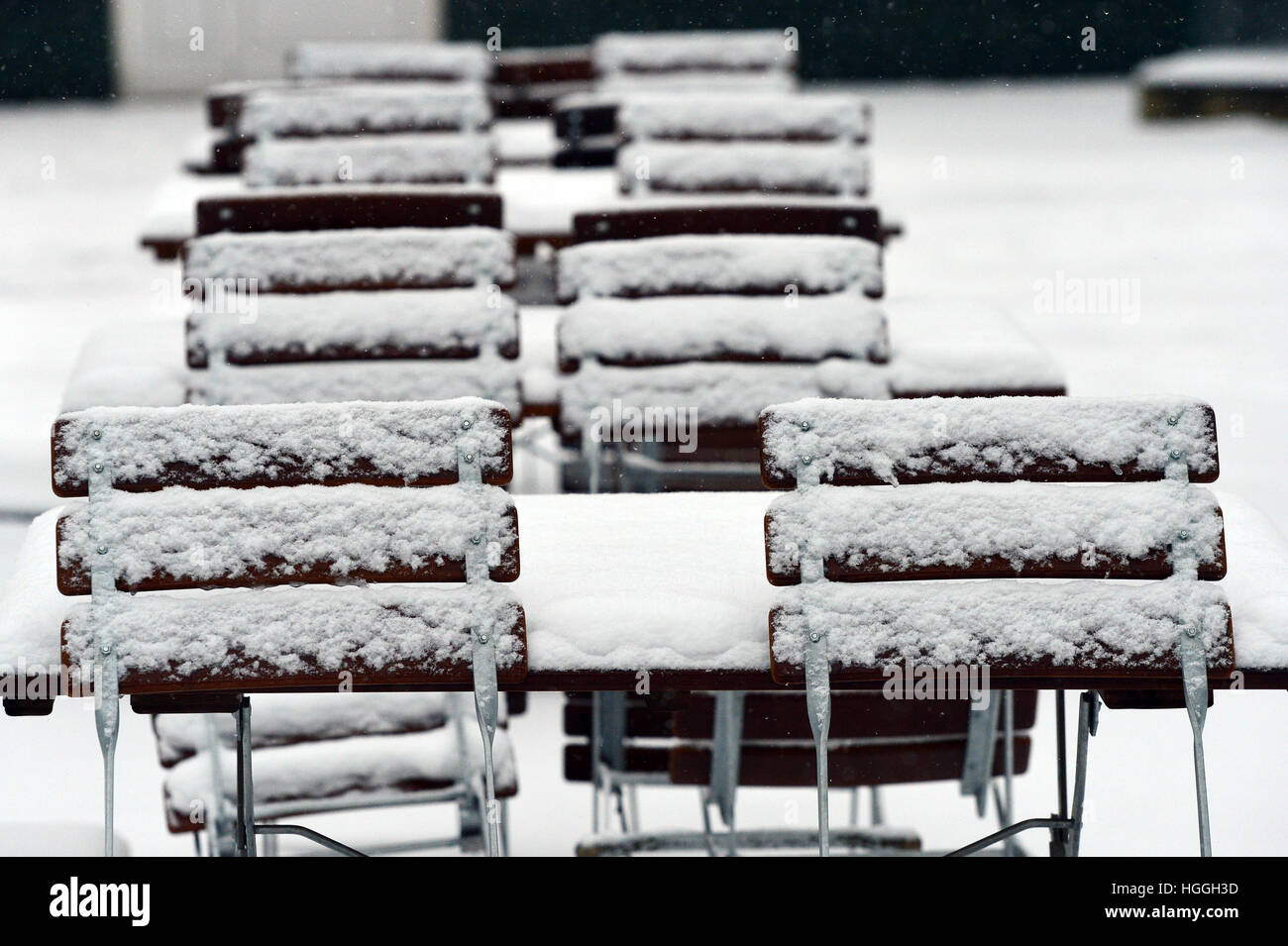 Chairs and tables of a restaurant are covered in snow in Berlin ...