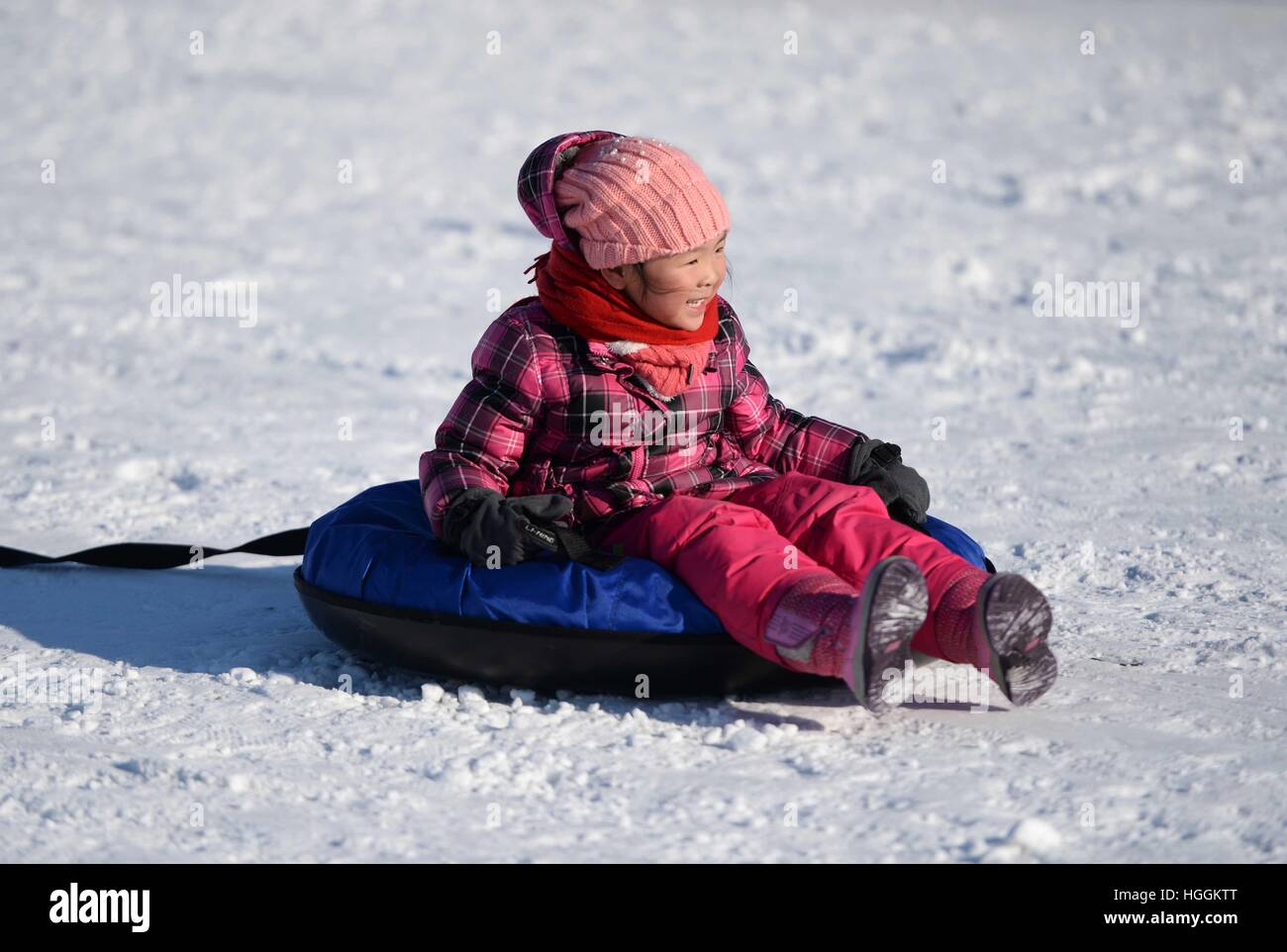 Harbin, China. 9th Jan, 2017. A girl goes sledding on her own at an ...