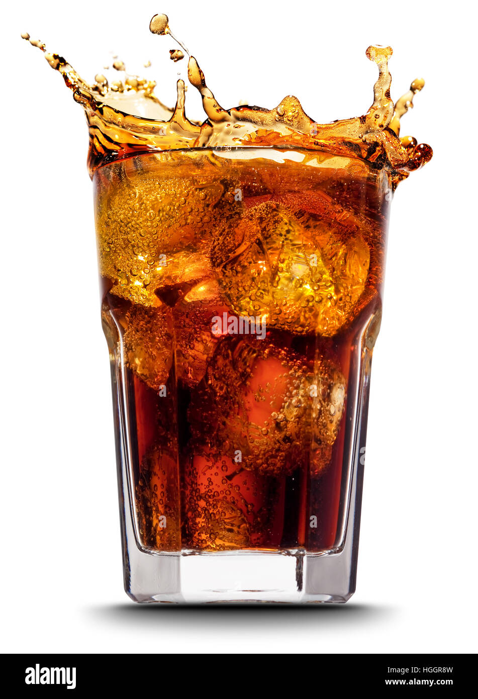 Ice cube droped in cola glass and cola splashing Stock Photo - Alamy