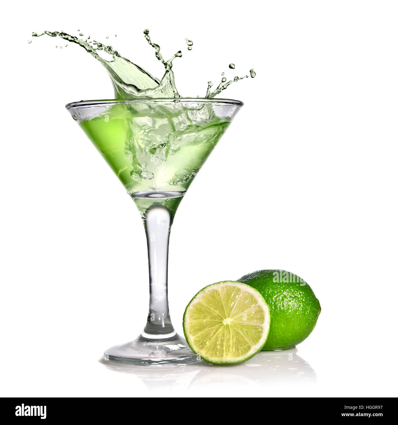 Green alcohol cocktail with splash and green lime Stock Photo - Alamy