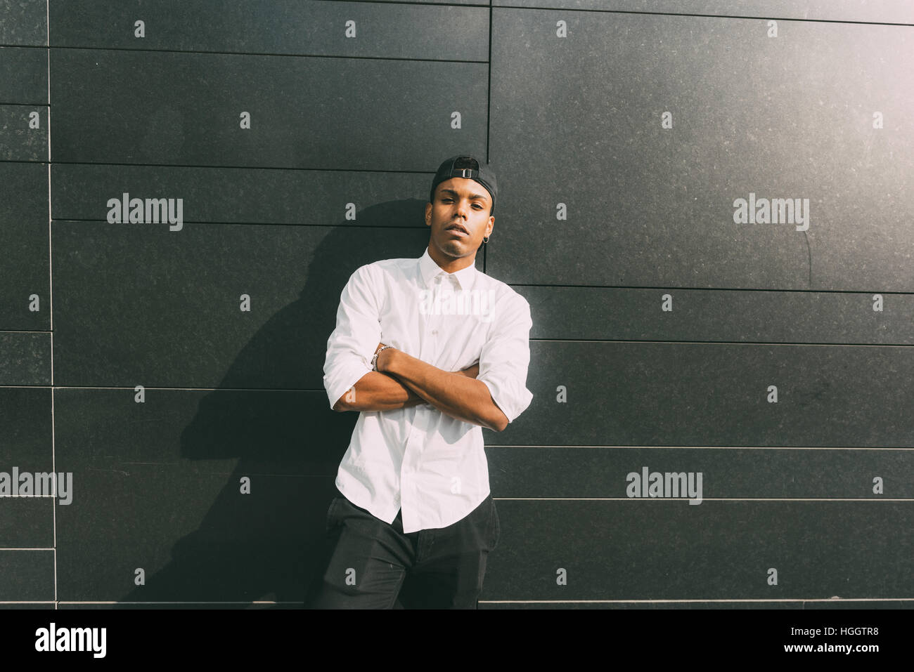 Young handsome american african man outdoor in city back light, looking ...