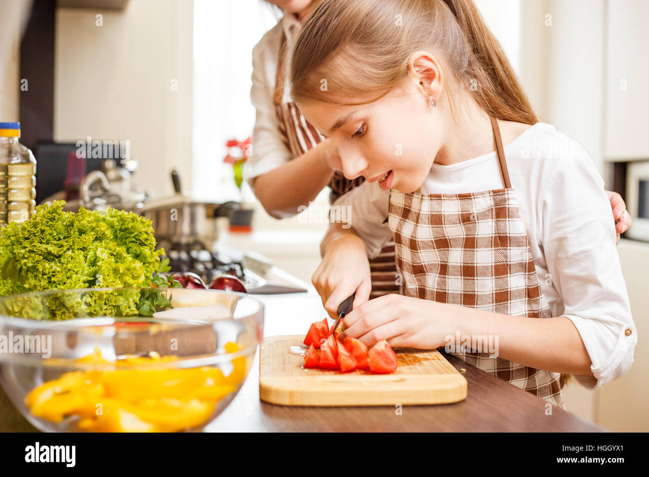 Young teenage girl cook together with her family Stock Photo - Alamy