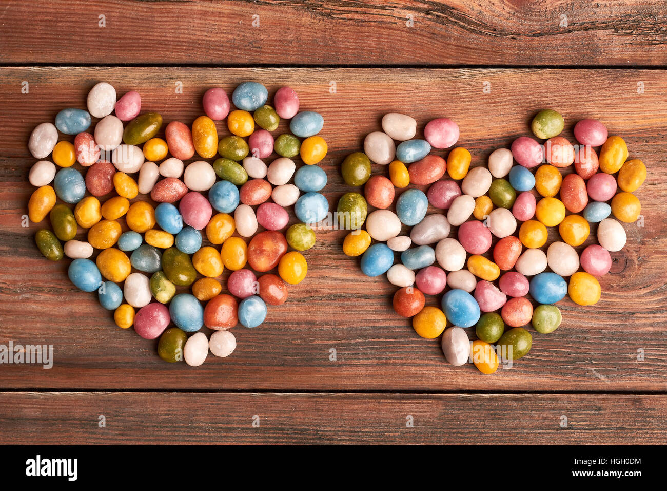 Colorful candy hearts on wood Stock Photo - Alamy