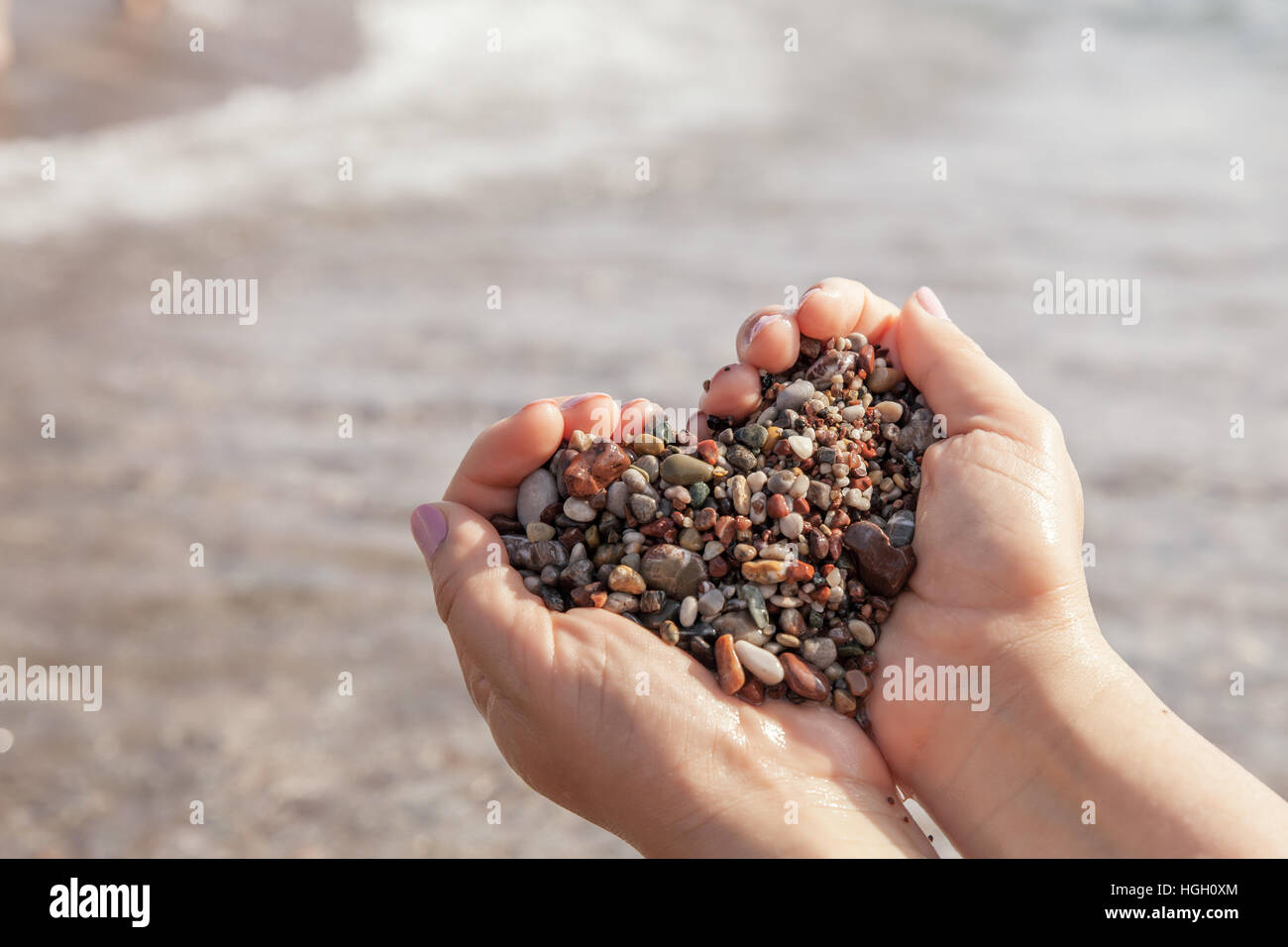 Hand Holding Stone Beach High Resolution Stock Photography and Images ...