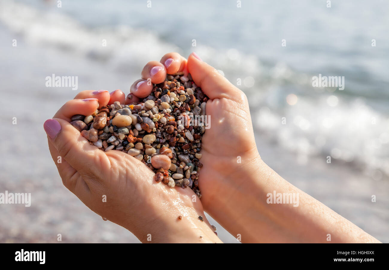 Hand holding stone heart hi-res stock photography and images - Alamy
