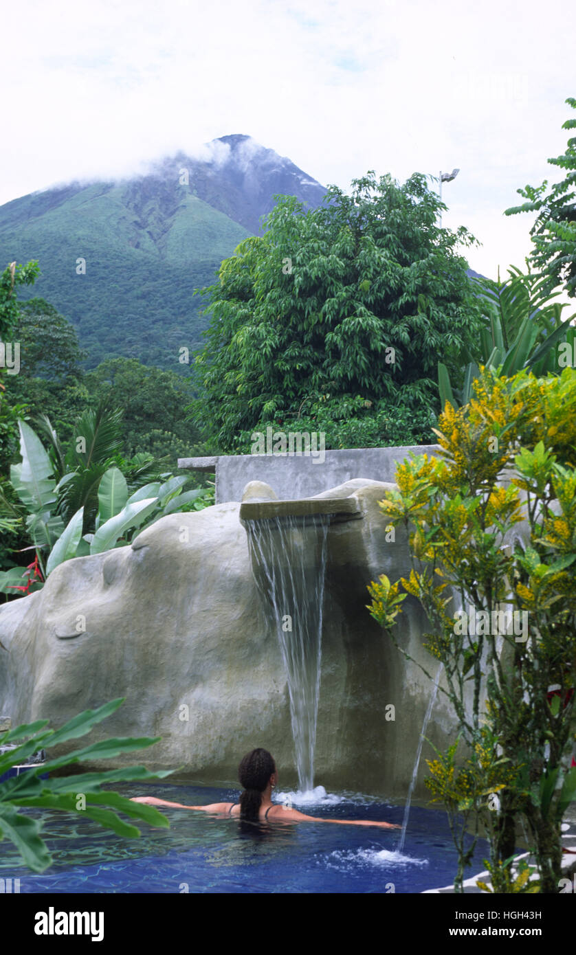 A woman is relaxing in a Thermal bath close to the volcano Arenal, La ...