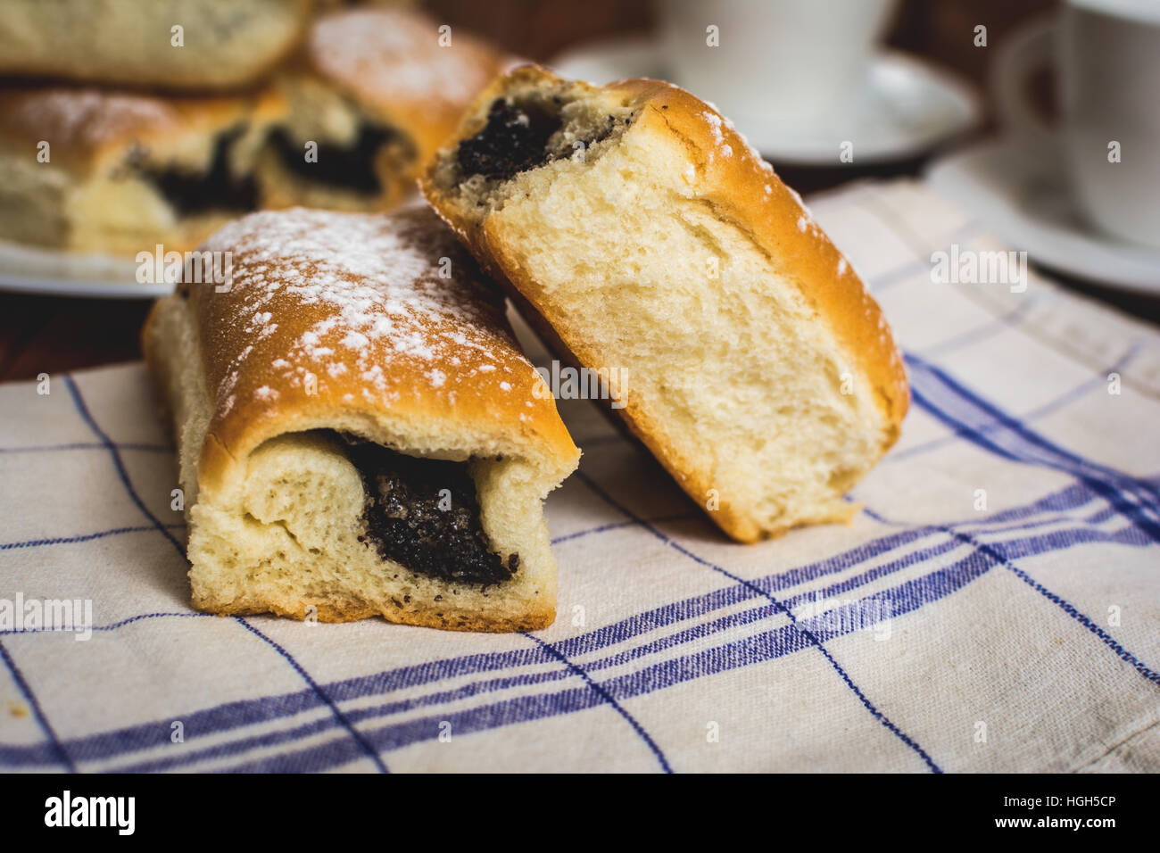 Baked sweet buns with poppy and coffee on wood table Stock Photo - Alamy