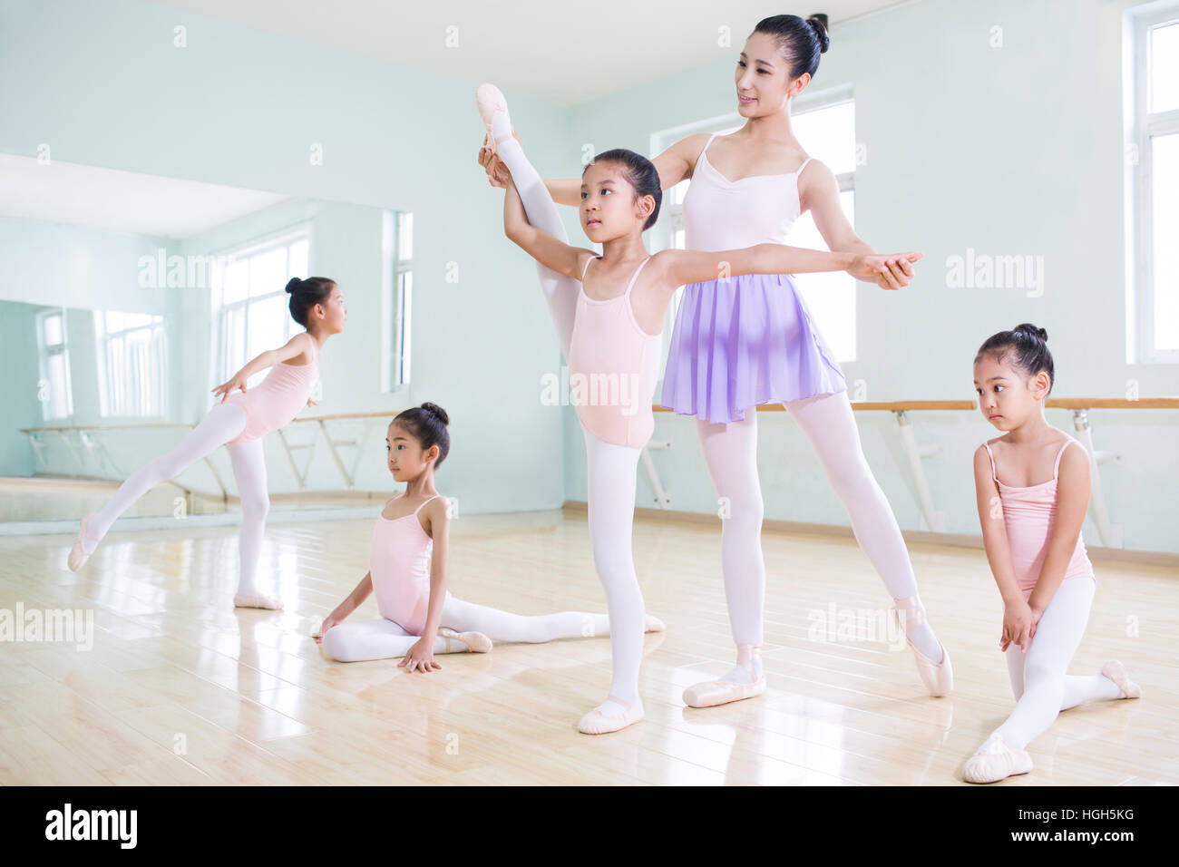 Young ballet instructor teaching girls in ballet studio Stock Photo - Alamy
