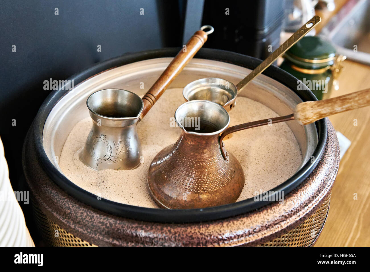 Preparation of Turkish coffee in the cezve in the sand at the cafe bar ...