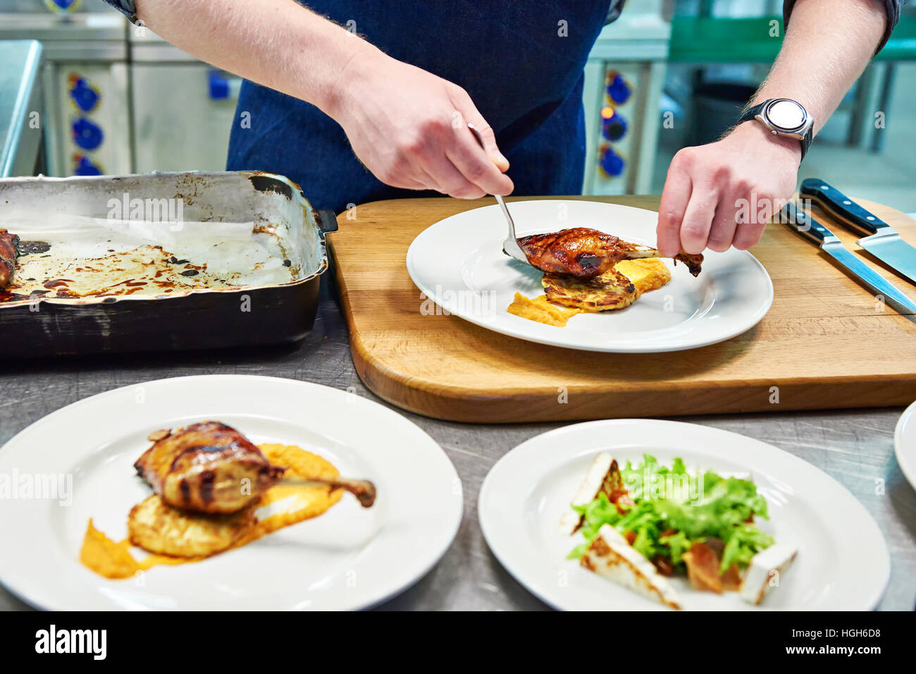 Cook are served at different dishes at the restaurant Stock Photo - Alamy