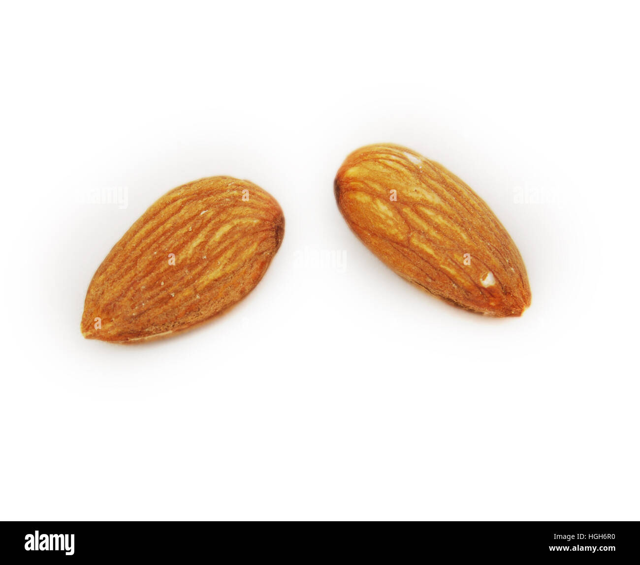Two whole almond nuts on white background Stock Photo - Alamy