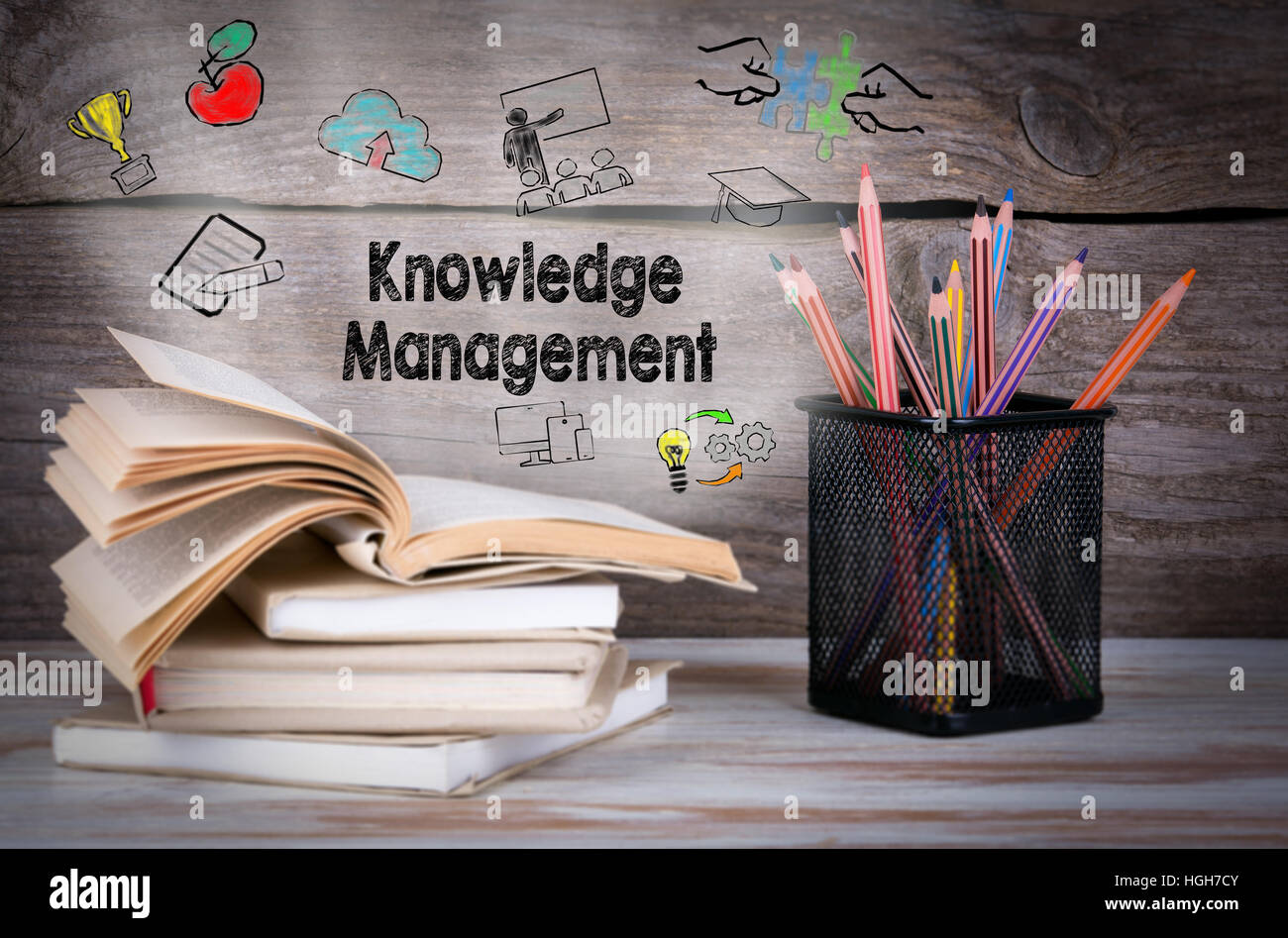 Knowledge Management. Stack of books and pencils on the wooden table ...