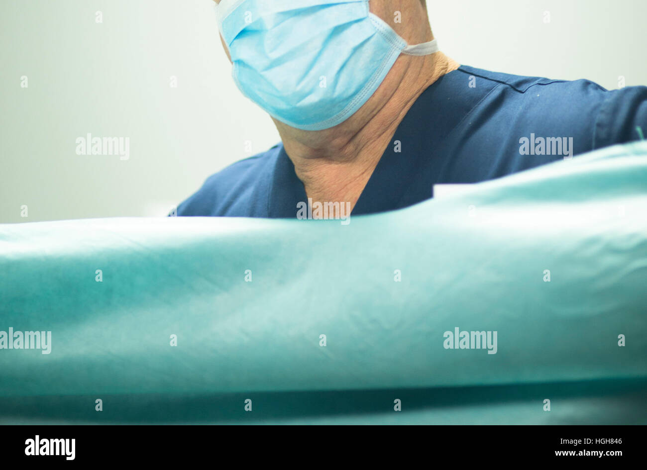 Surgeon in hospital surgery in sterile uniform "scrubs" and mask in ...