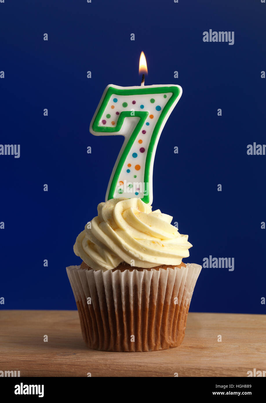 Cupcake with a number seven candle with a Blue Background Stock Photo ...