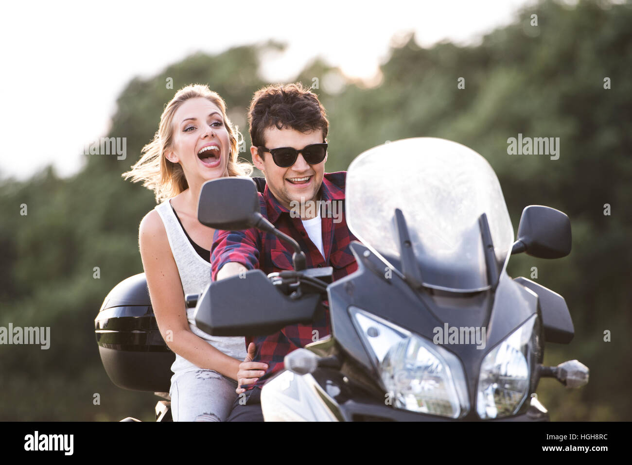 Couple in love enjoying a motorbike ride in countryside Stock Photo - Alamy