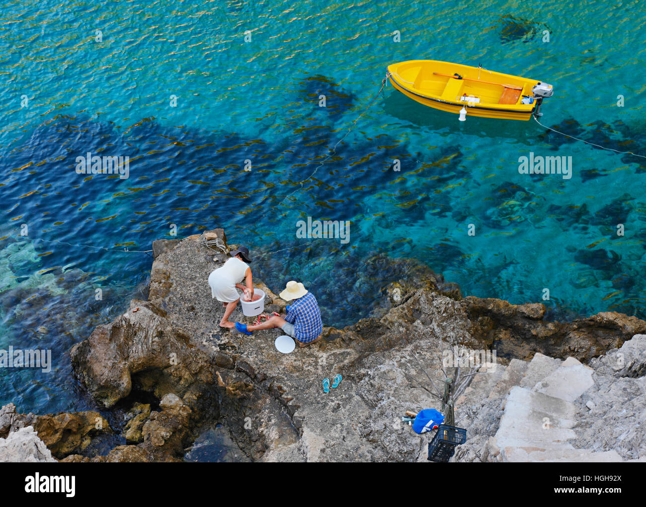 Husband and wife cleaning fish for lunch on the Island of Mljet ...