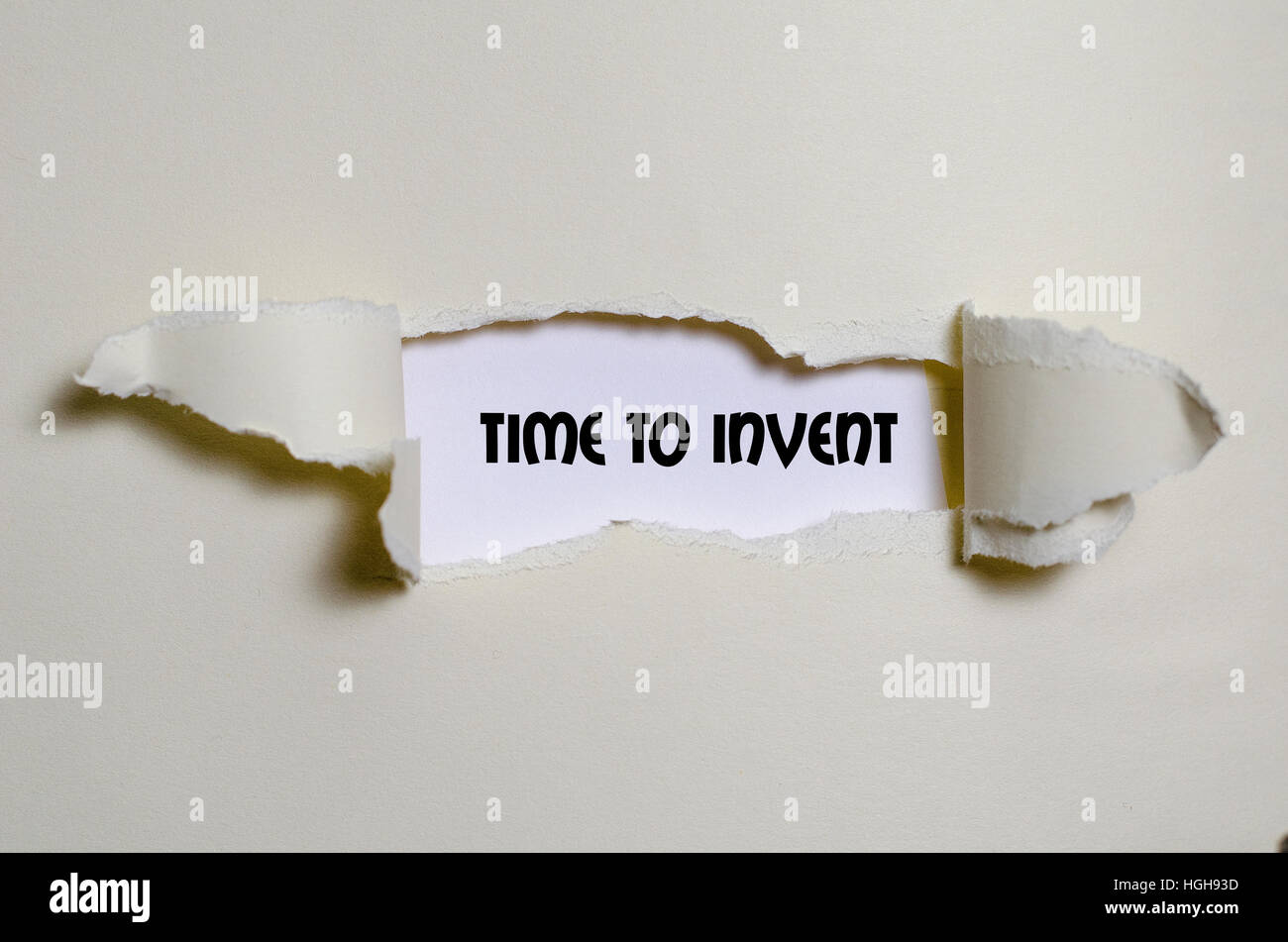 The word time to invent appearing behind torn paper Stock Photo - Alamy