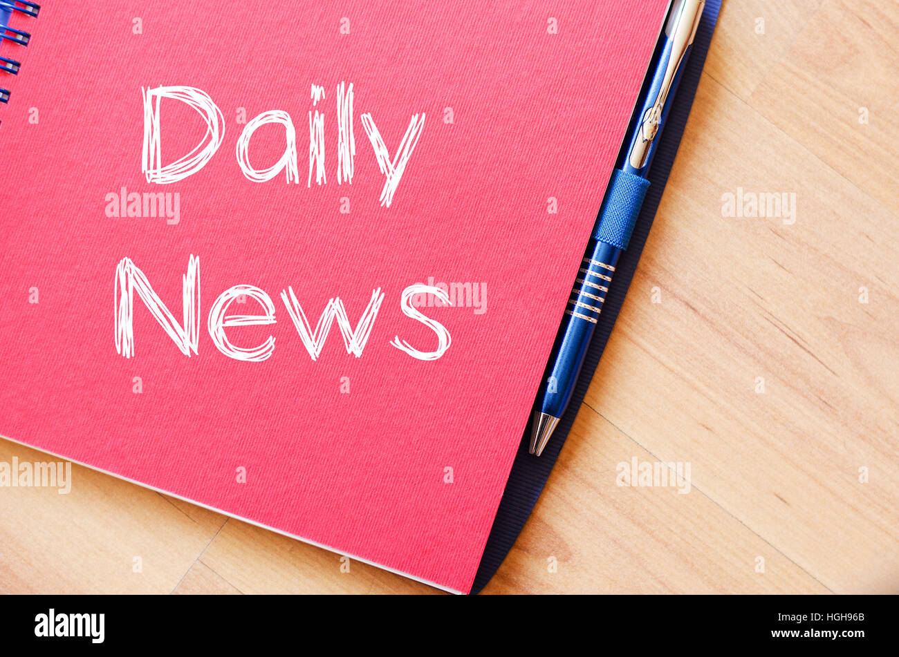 Daily news text concept write on notebook Stock Photo - Alamy
