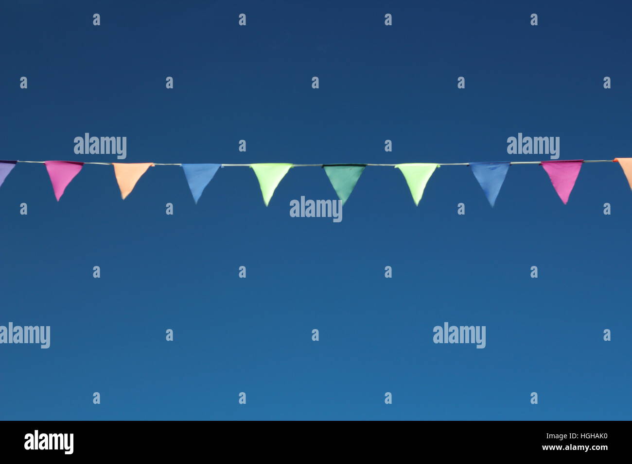 Bunting strung up high above the street of a English village during its ...