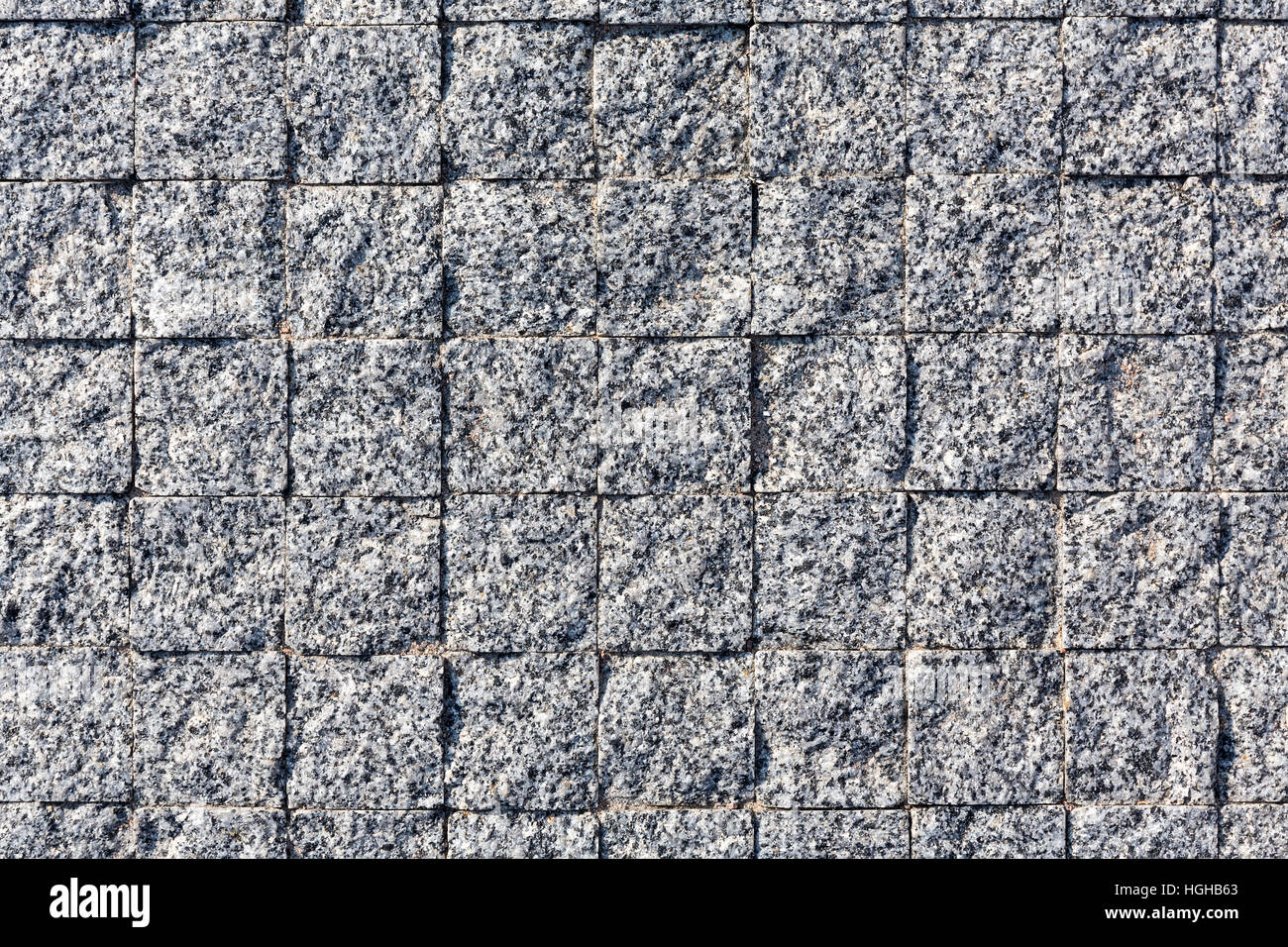 Cobblestone sidewalk made of small cubic stones Stock Photo - Alamy