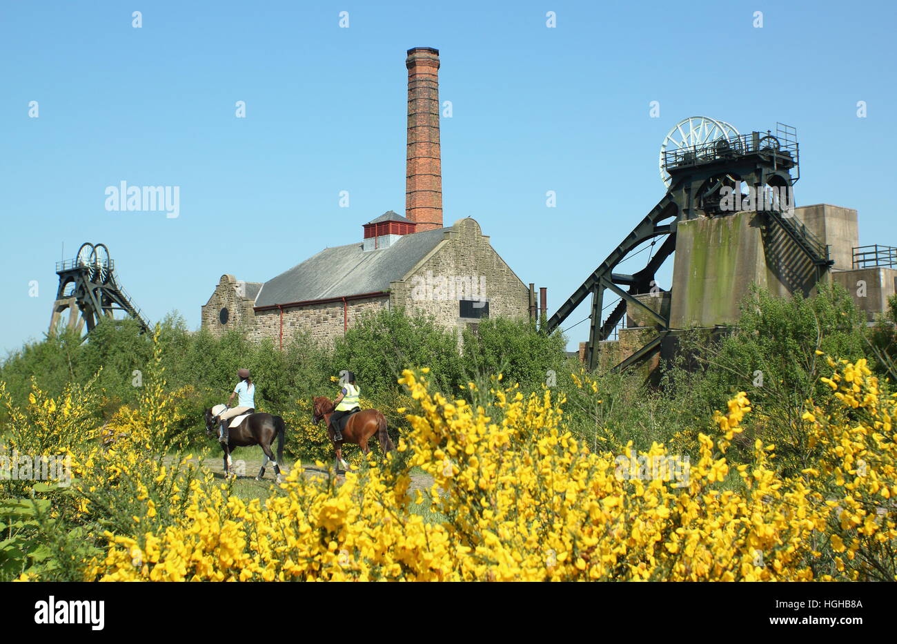 Horse riders pass by Pleasley Pit; a former coal mine turned heritage ...