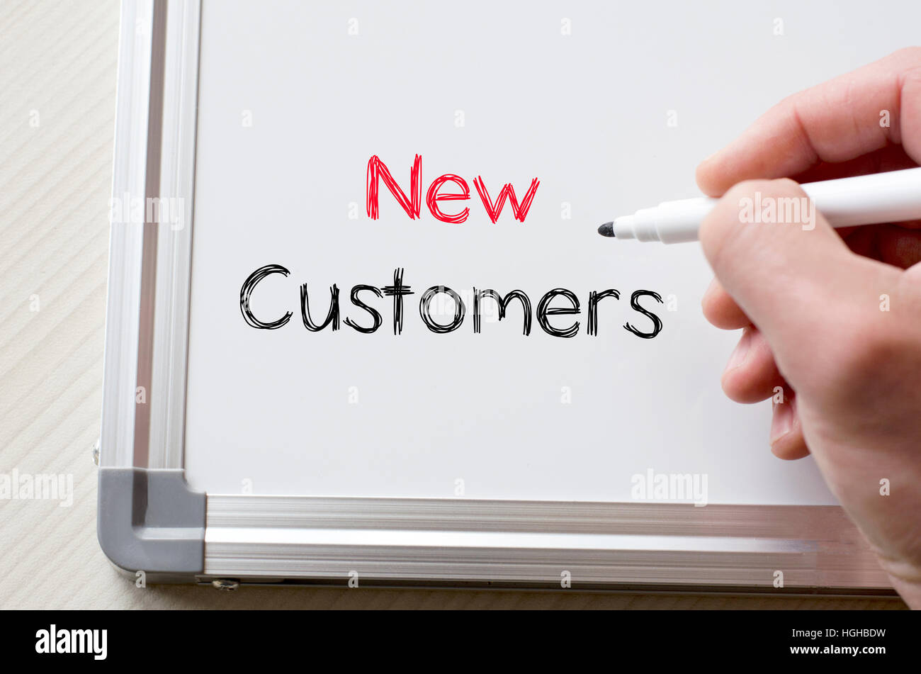 Human hand writing new customers on whiteboard Stock Photo - Alamy