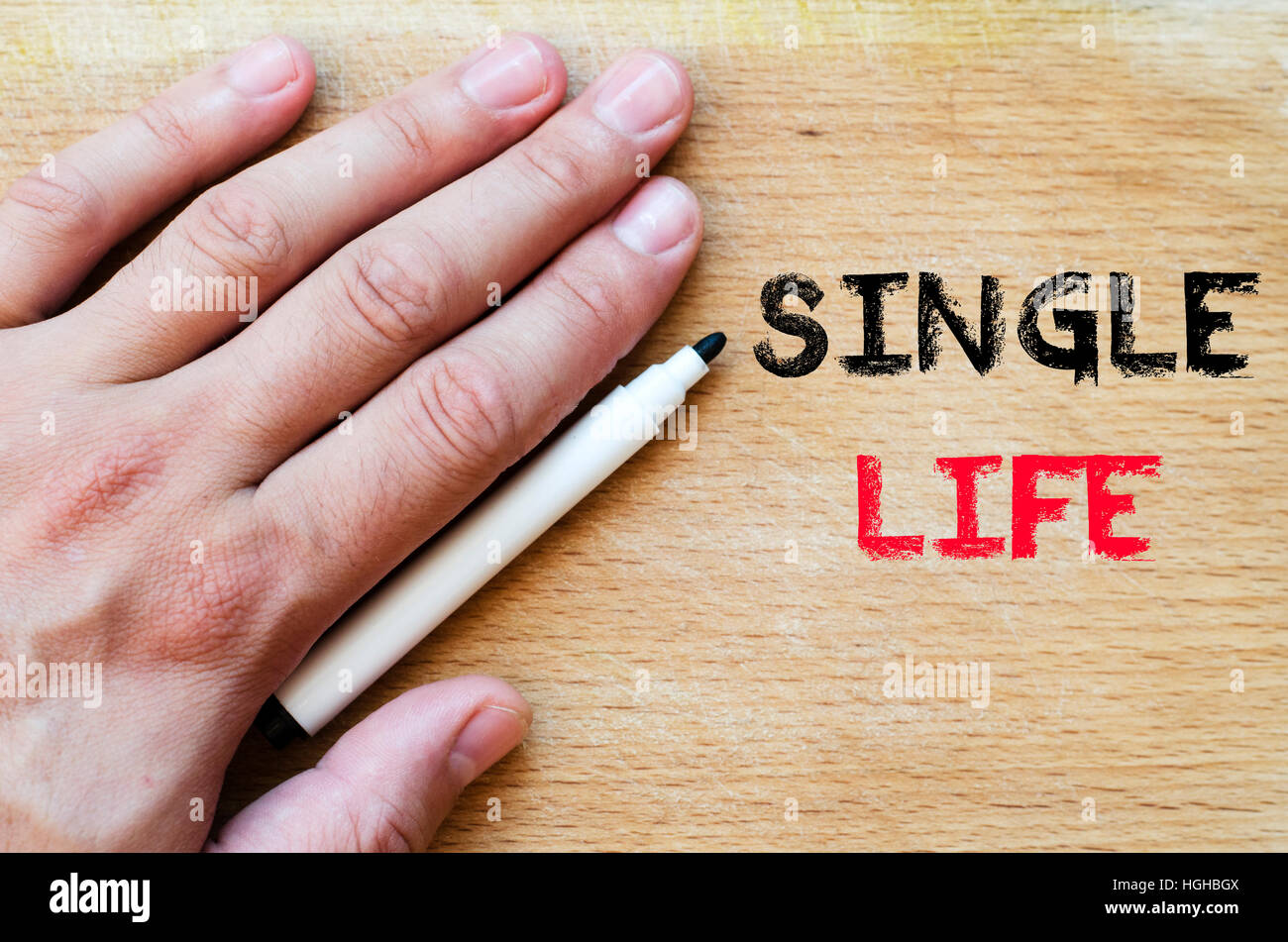 Human hand over wooden background and single life text concept Stock ...