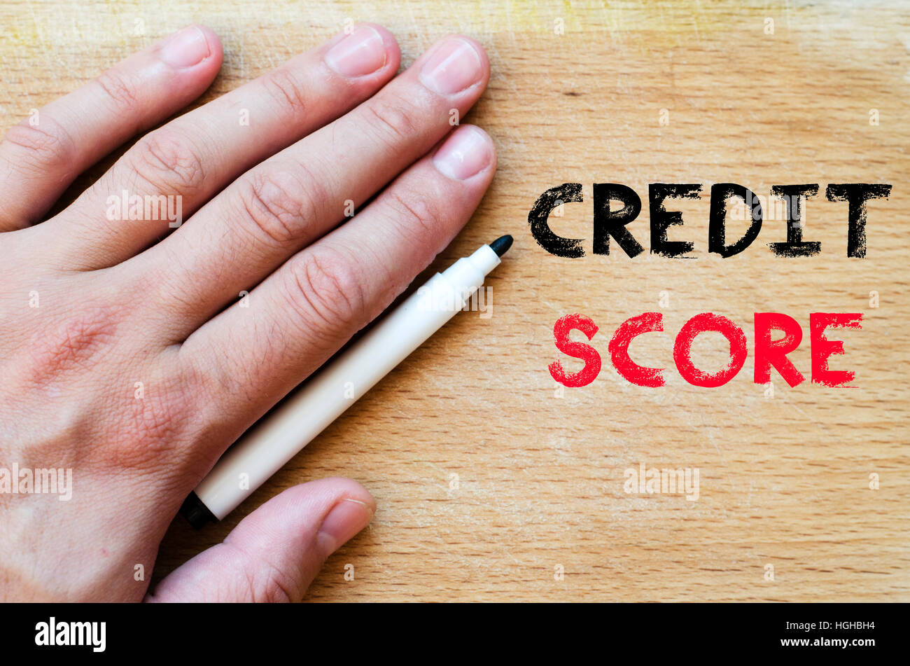 Human hand over wooden background and credit score text concept Stock ...