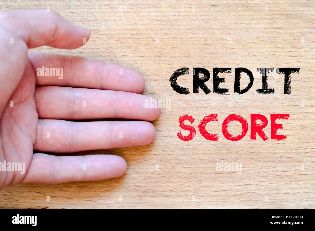 Human hand over wooden background and credit score text concept Stock ...