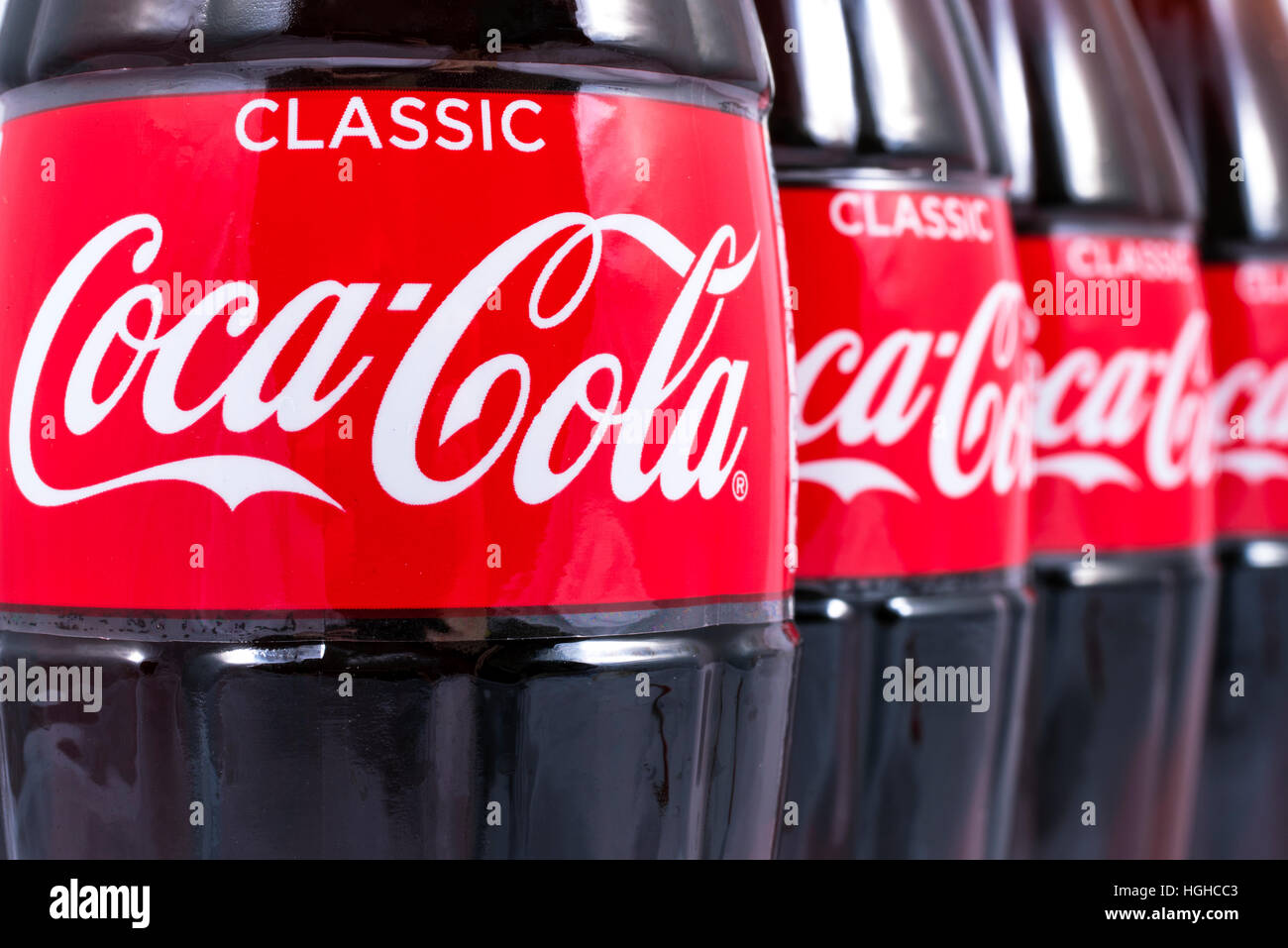 LONDON, UK - JANUARY 4TH 2017: Bottles of Coca Cola drink over a plain ...
