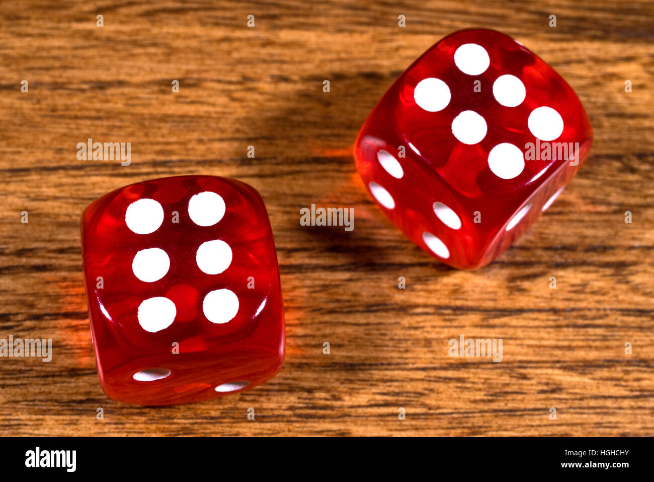 Two red dice on a tabletop Stock Photo - Alamy
