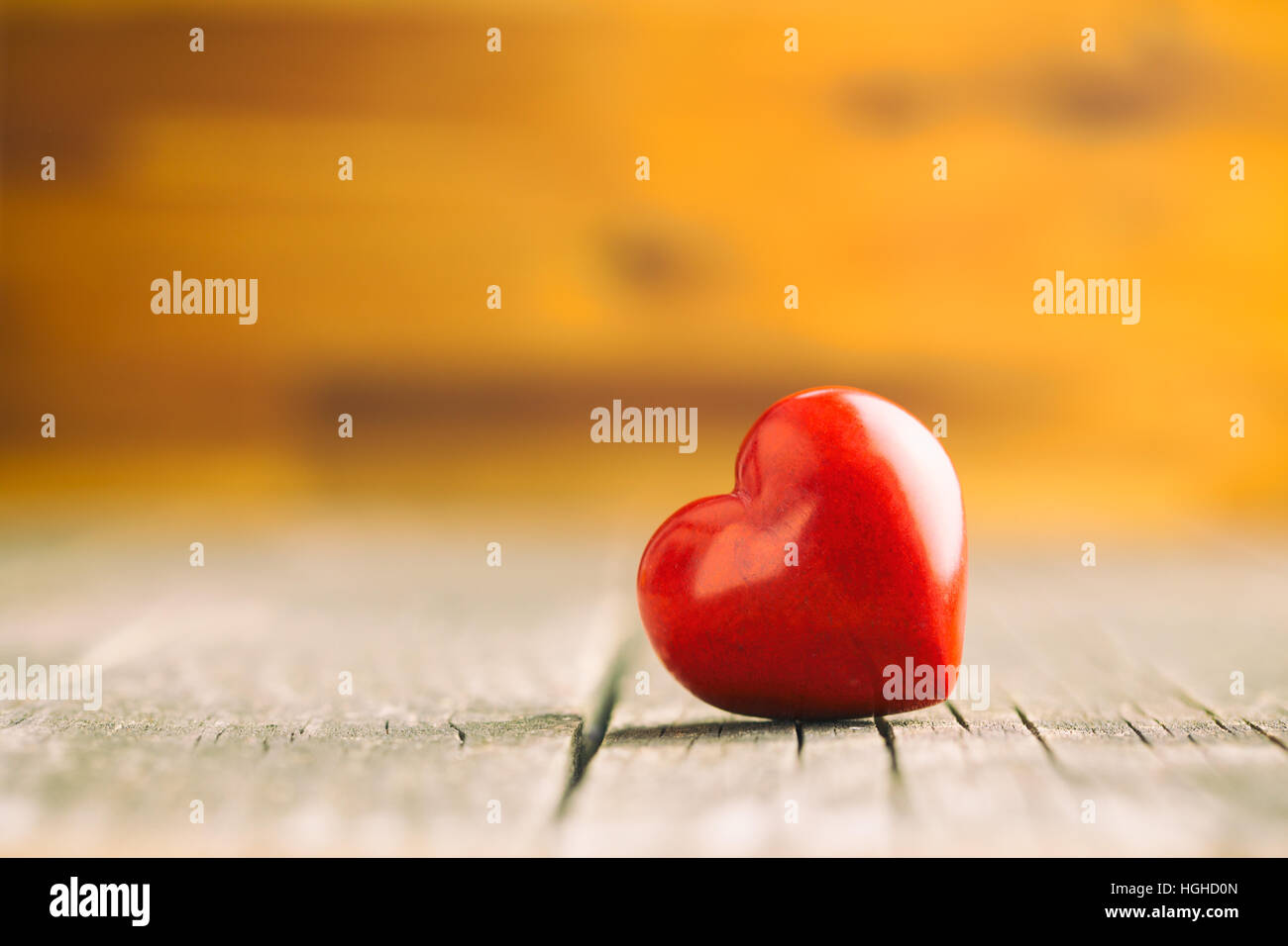 Red heart on old wooden table Stock Photo - Alamy