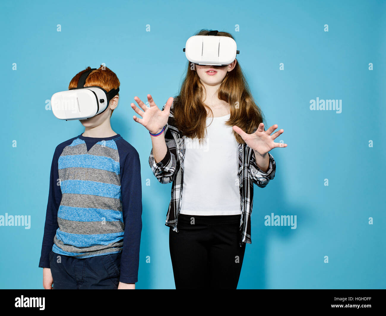 Boy and girl wearing virtual reality head gear, VR Glasses Stock Photo ...