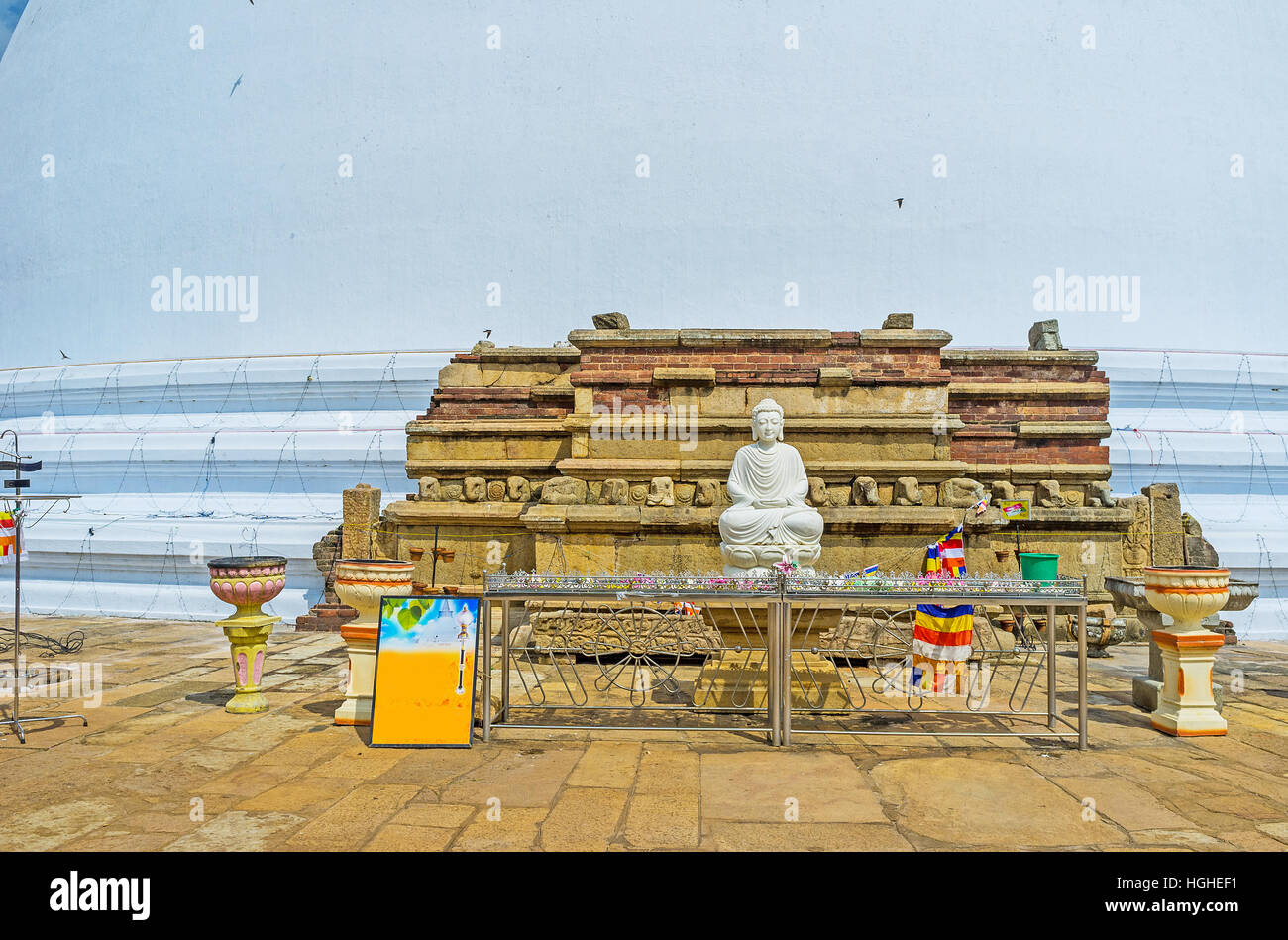 The old altar of Mirisawetiya Stupa with the modern statue of ...