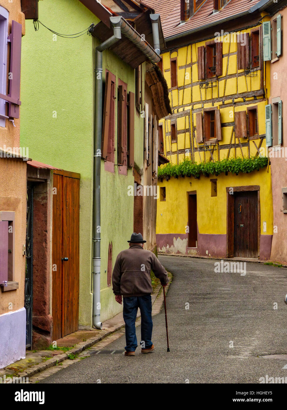 Old man walking European street Stock Photo - Alamy