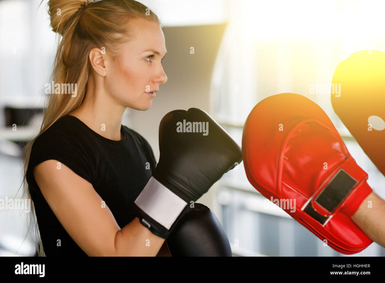 Girl engaged boxing with coach Stock Photo - Alamy