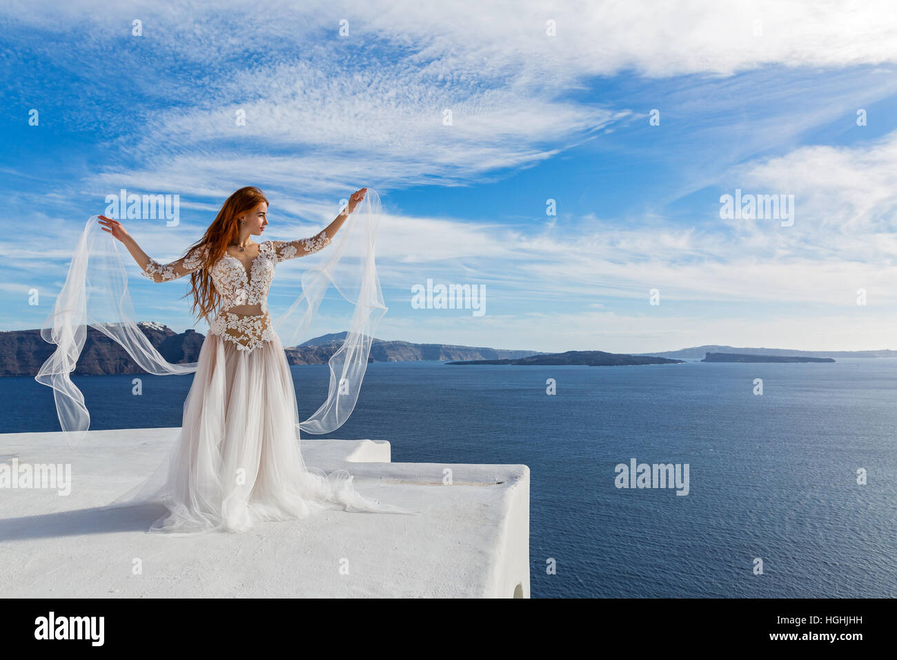 Beautiful young woman in white dress and island Santorini Stock Photo ...