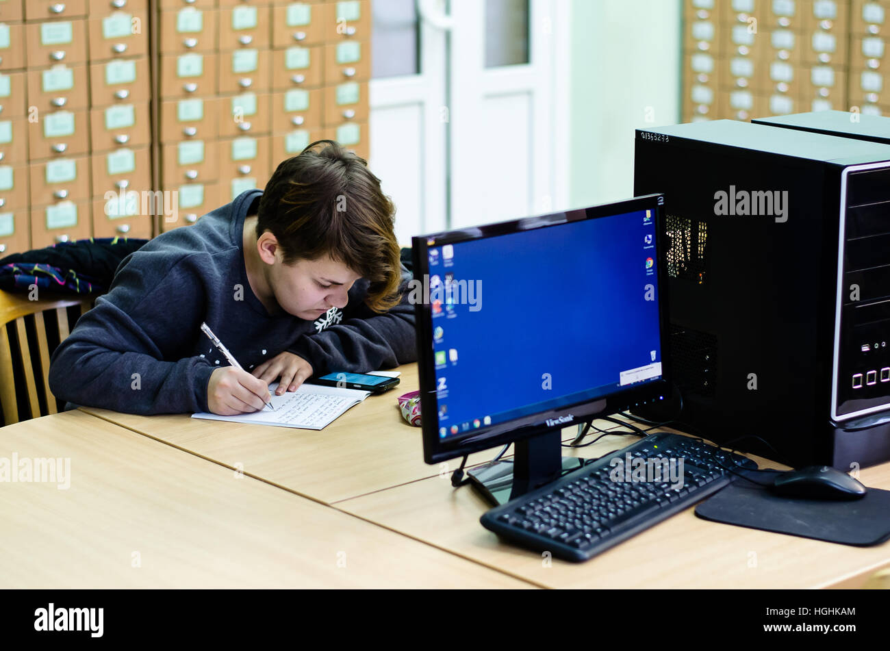 Day in library with books, student, librarians, computers and laptops ...
