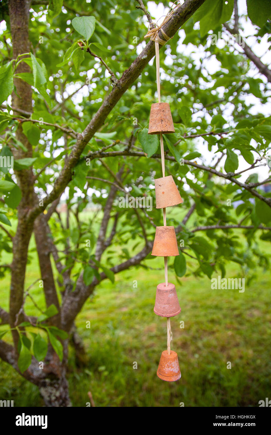 Hanging mobile in a tree realized with terracotta flowerpot (Europe ...