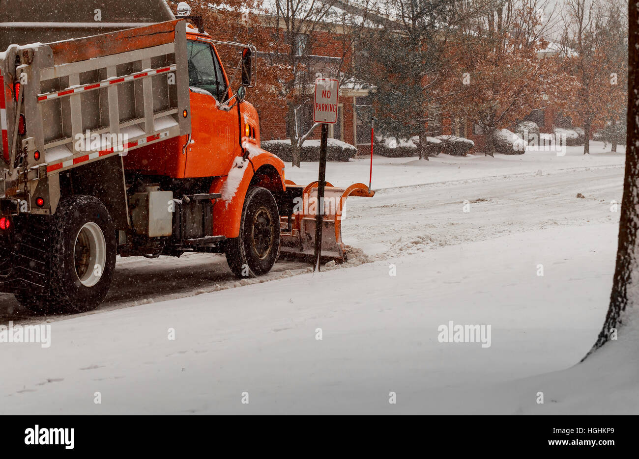 Snow clearing. Tractor clears the way after heavy snowfall. Winter snow ...